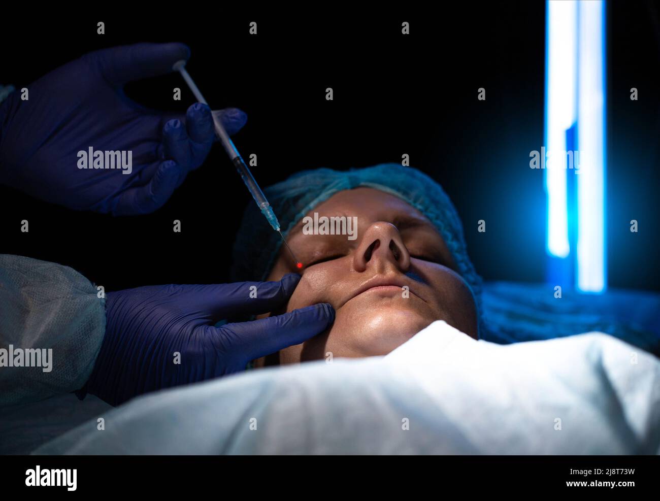 Doctor cosmetologist makes mesotherapy beauty injections into the eye ...