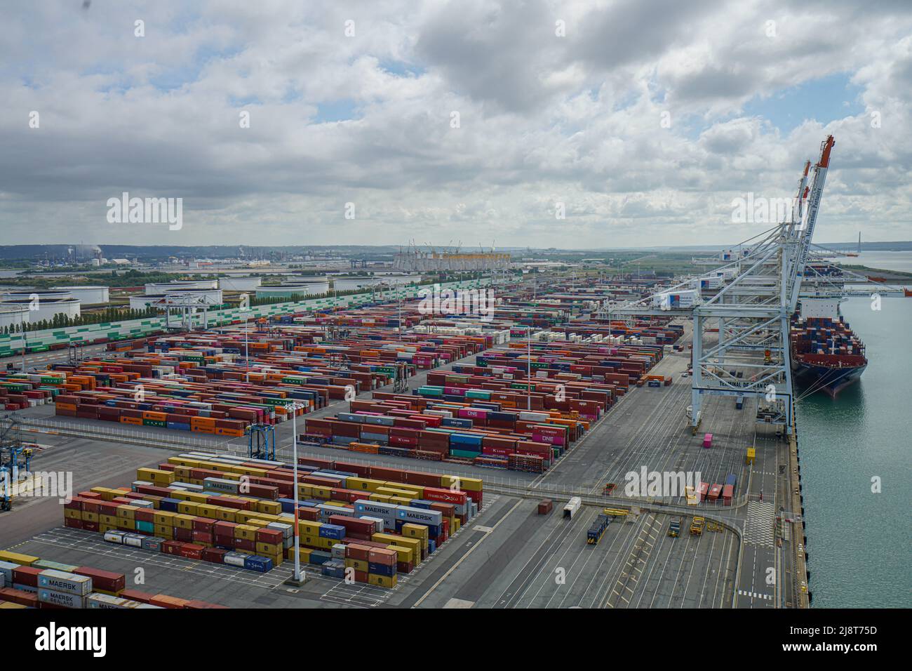 General view of container ship unloading under giant gantries at a ...