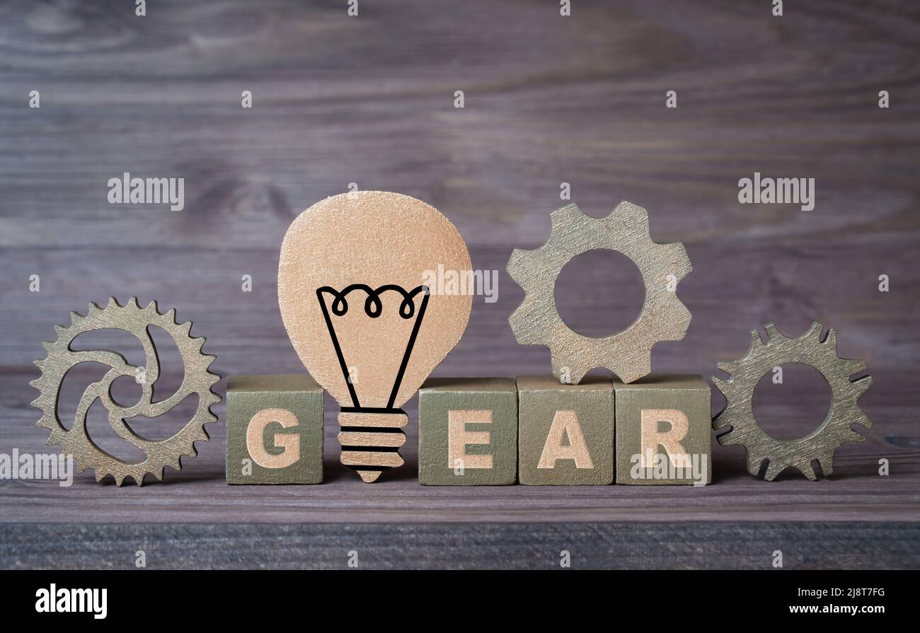 Word GEAR made from letter blocks with cogs and a wooden lightbulb ...