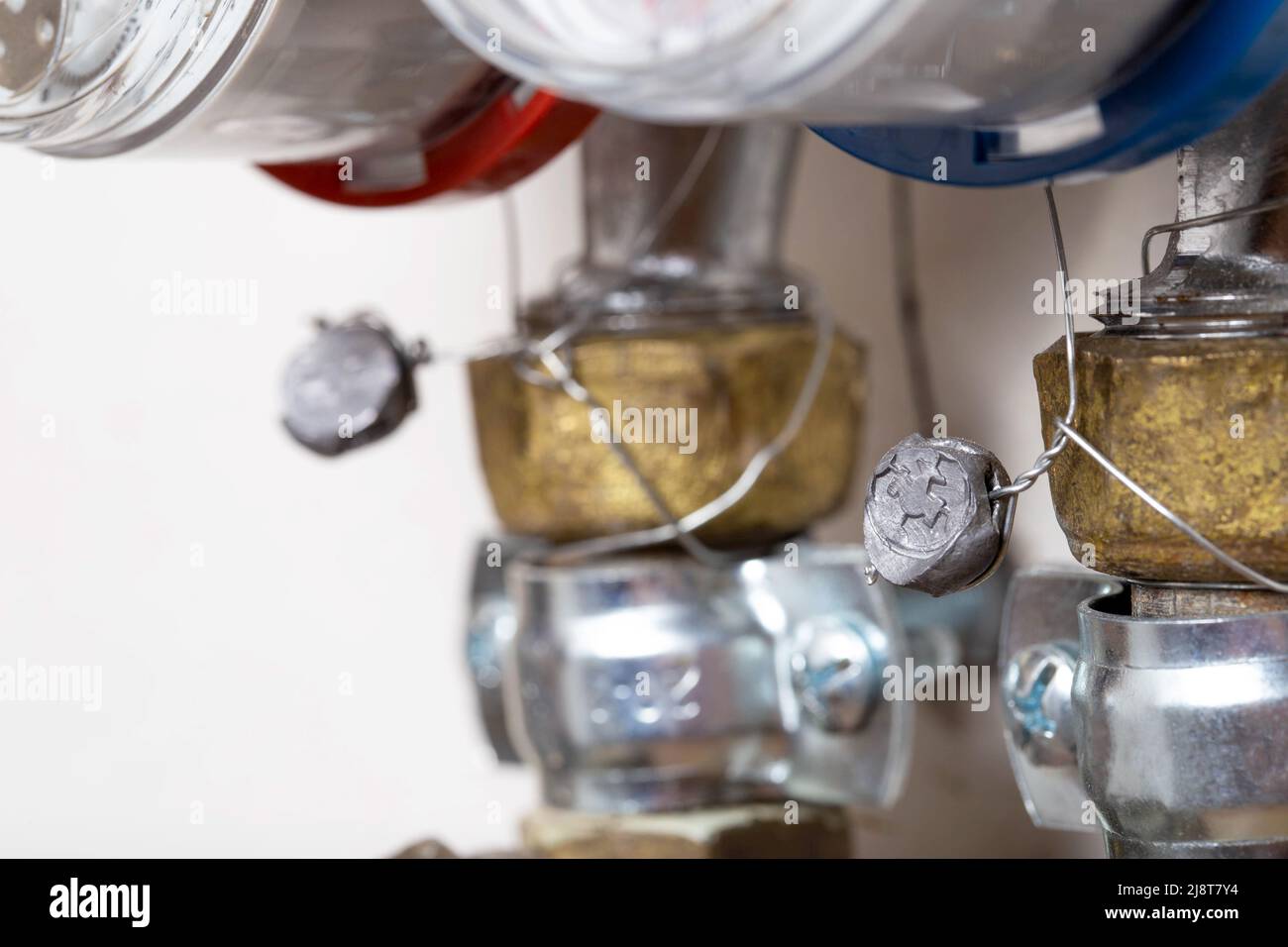 Water metering seals on water meters, macro Stock Photo - Alamy
