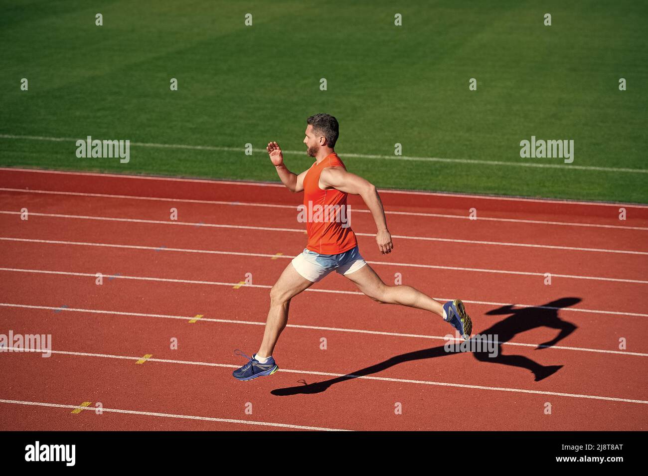 outdoor stadium sprint. physical training. athletic guy run. challenge and competition Stock ...