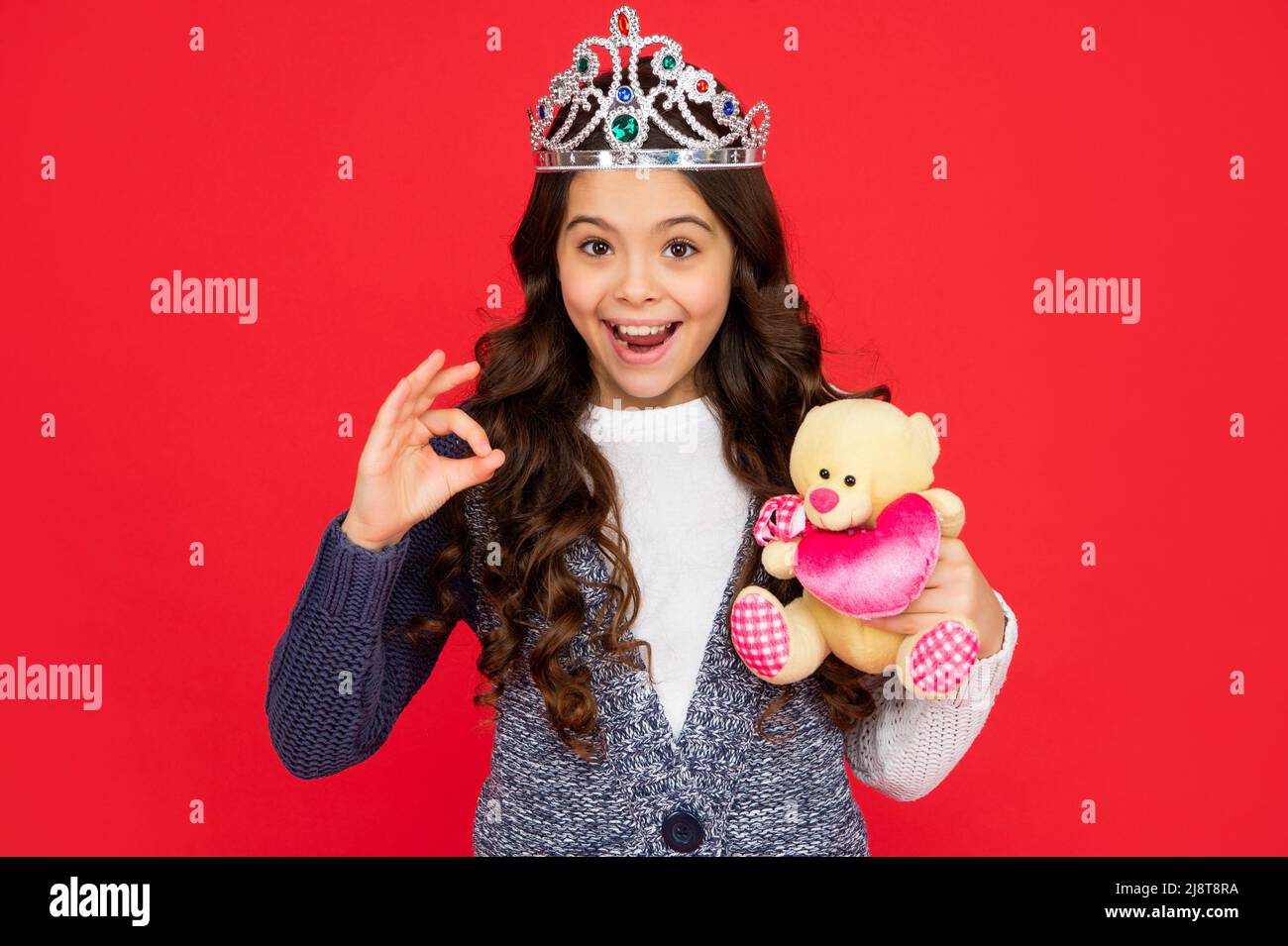 surprised child in queen crown. princess in tiara. kid hold bear toy ...