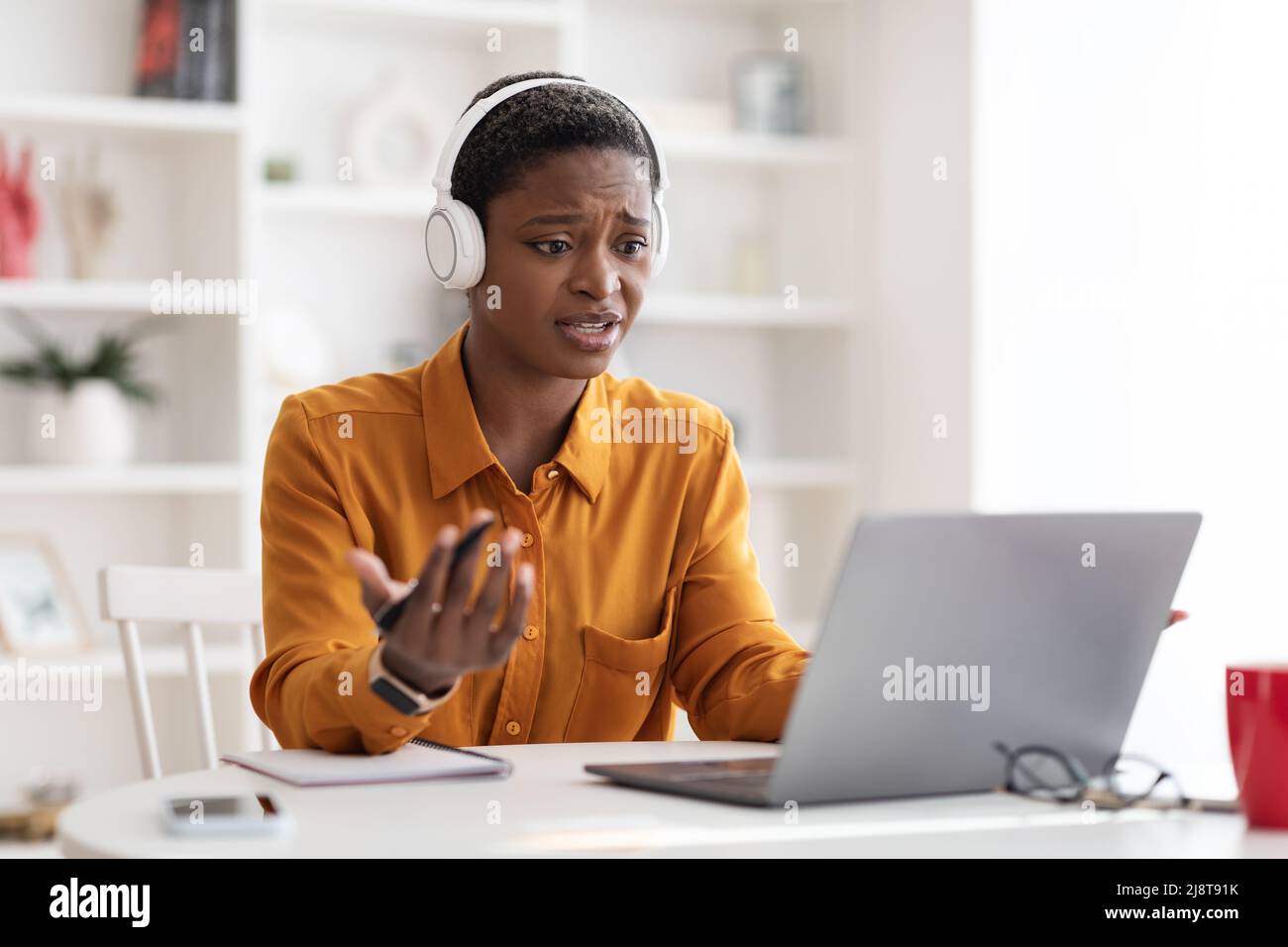 Disappointed black lady employee having video chat with colleagues ...