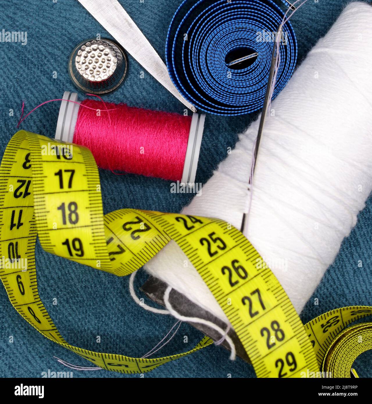 Sewing accessories on fabric backdrop Stock Photo - Alamy