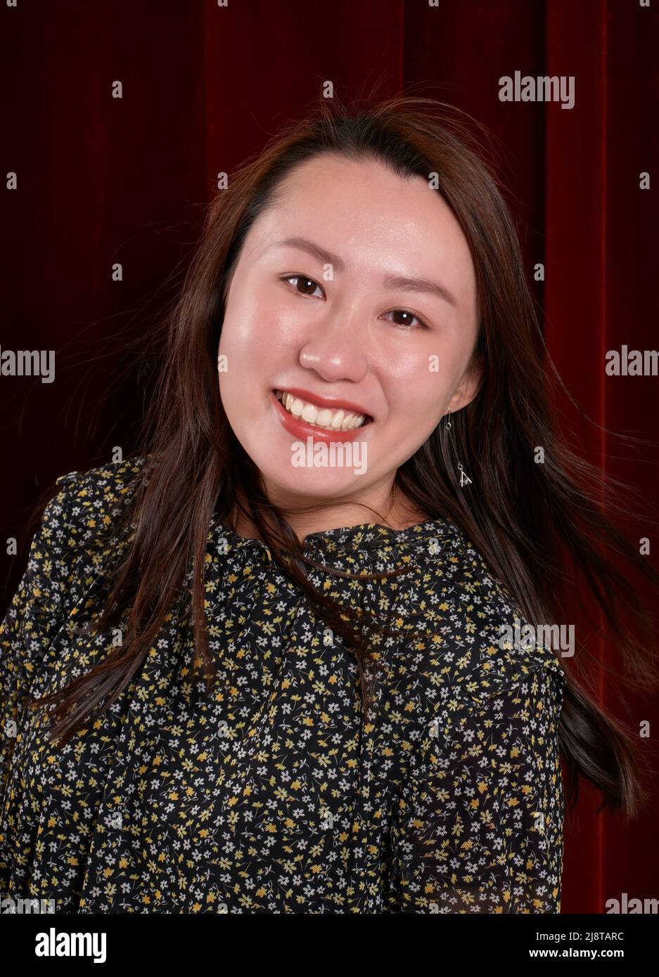 Young Hong Kong Chinese woman wearing long-sleeved patterned dress ...