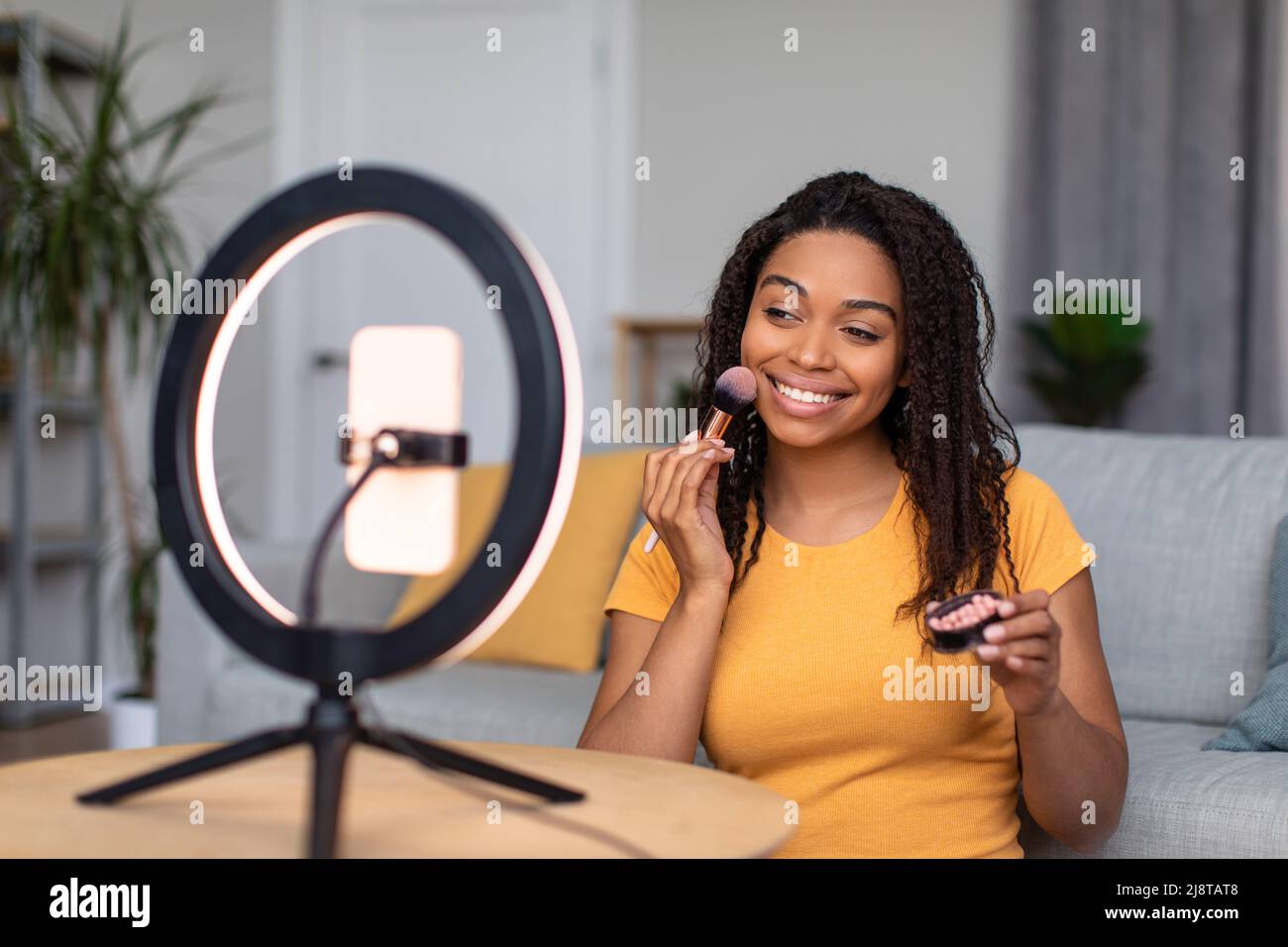 Beauty blogging concept. Happy black lady recording makeup review ...