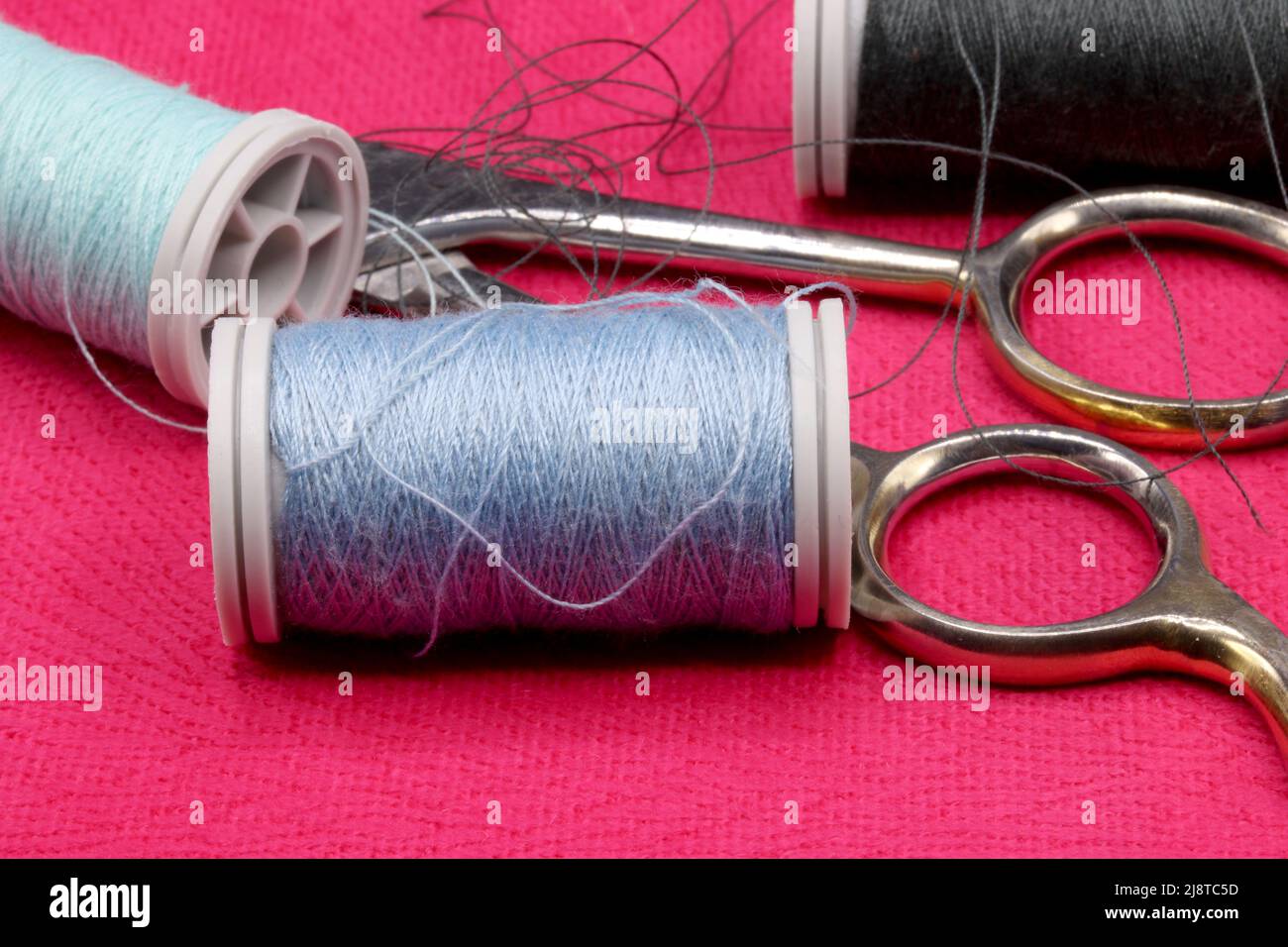 Sewing accessories on fabric backdrop Stock Photo - Alamy