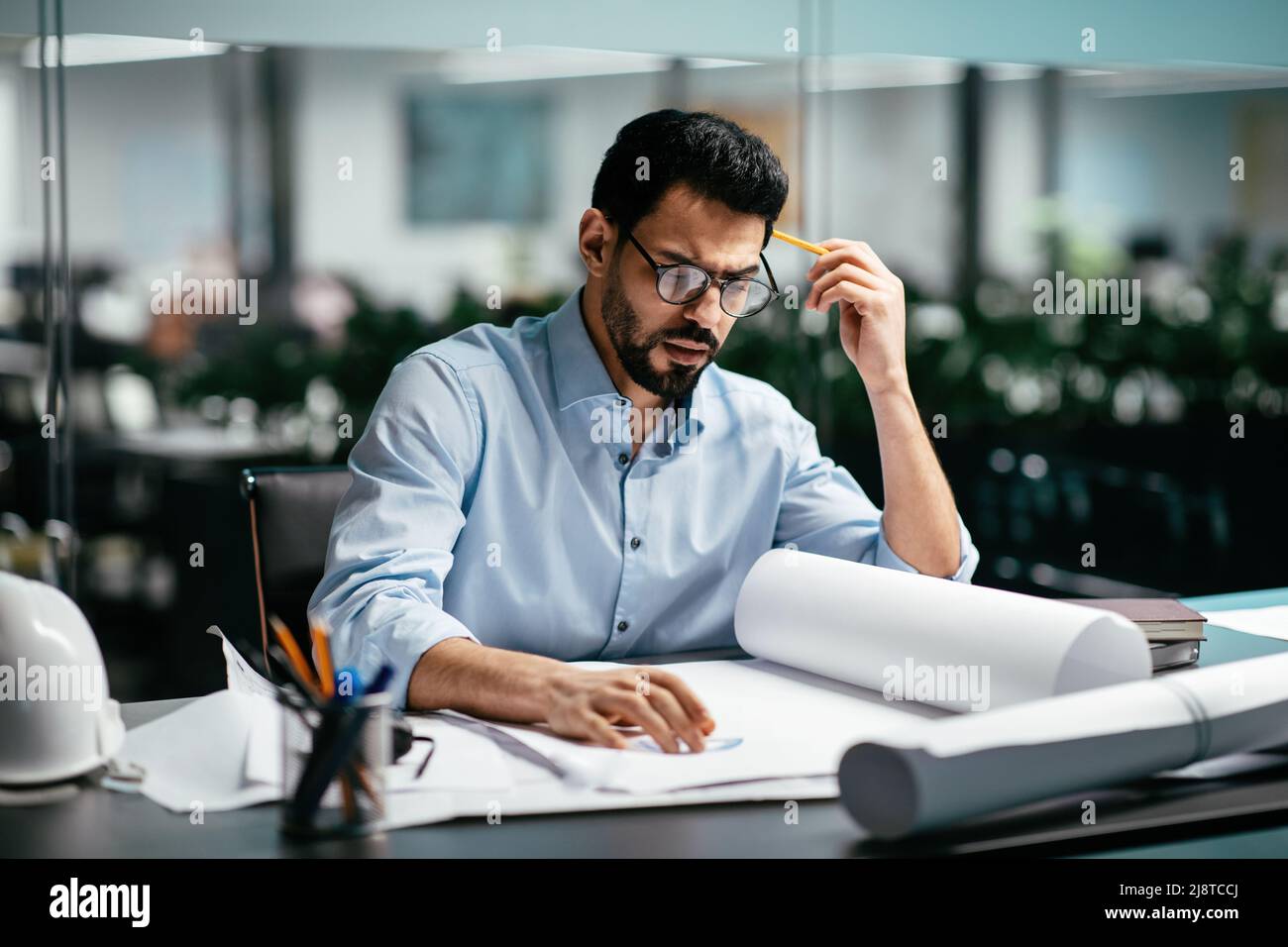 Concentrated busy smart attractive young arab man engineer with beard ...