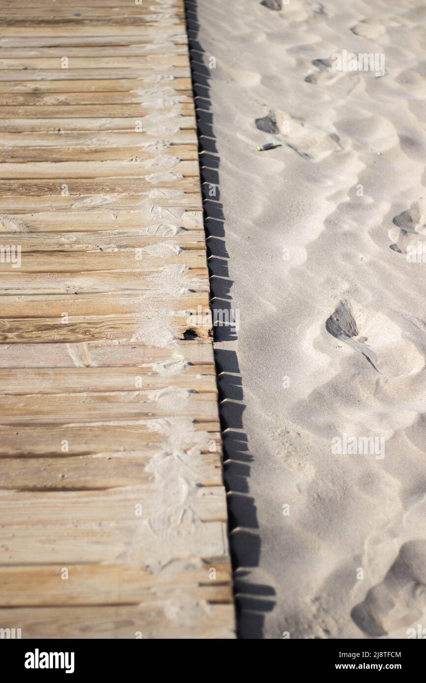 Wooden walkway leading to the beach surrounded by golden sand on the ...