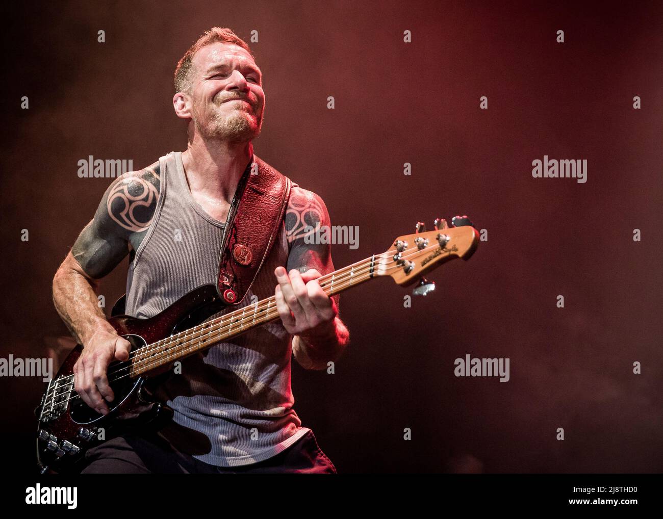 Bassist Tim Commerford performing live on stage with Prophets of Rage ...