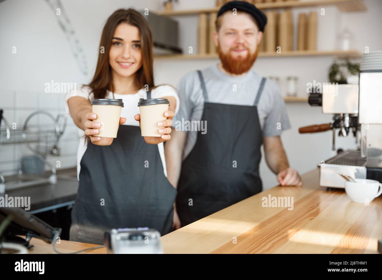 Coffee Business Concept - Positive young bearded man and beautiful ...