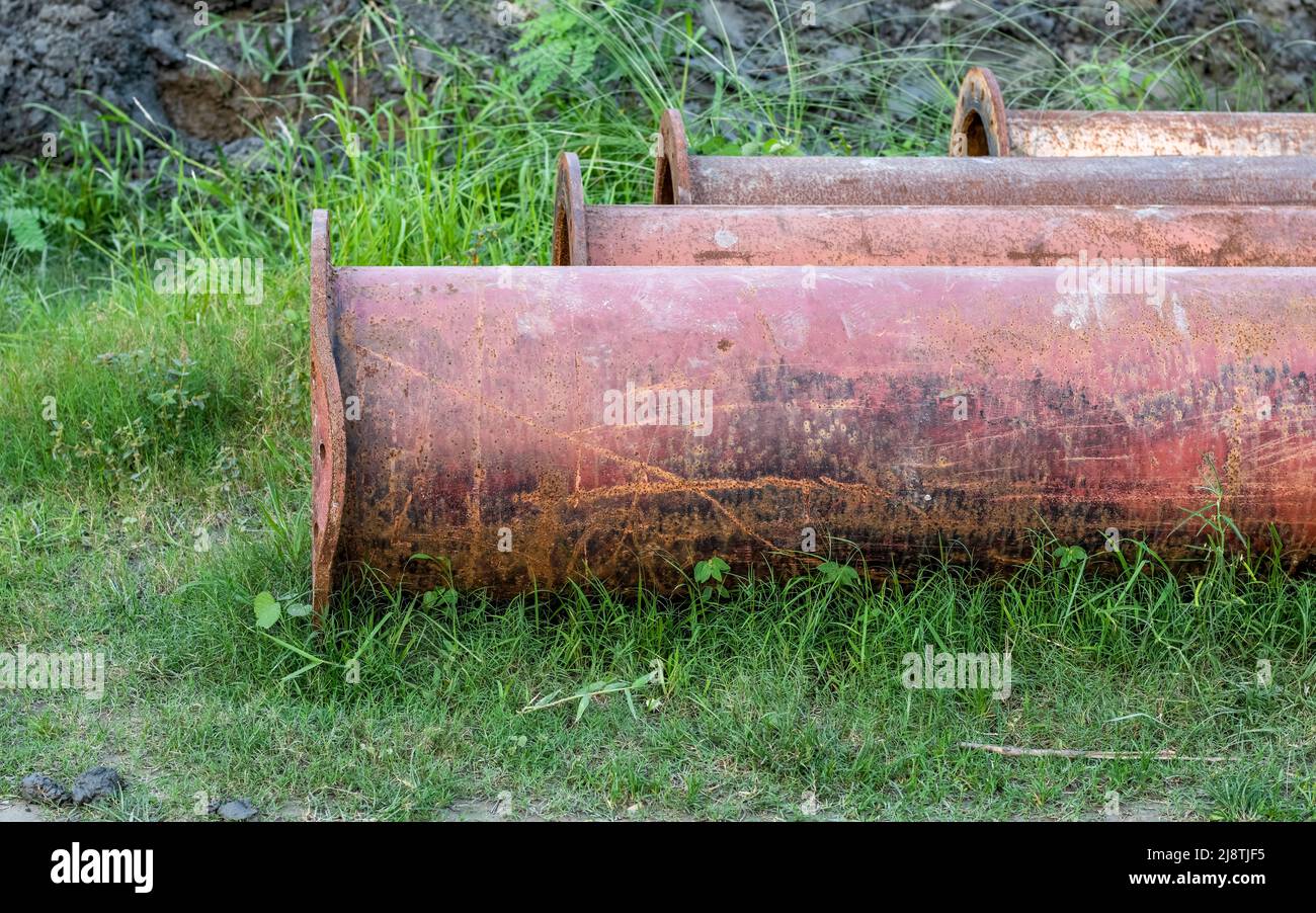 Rustic old dredging pipes stored on a meadowland close up shot Stock ...