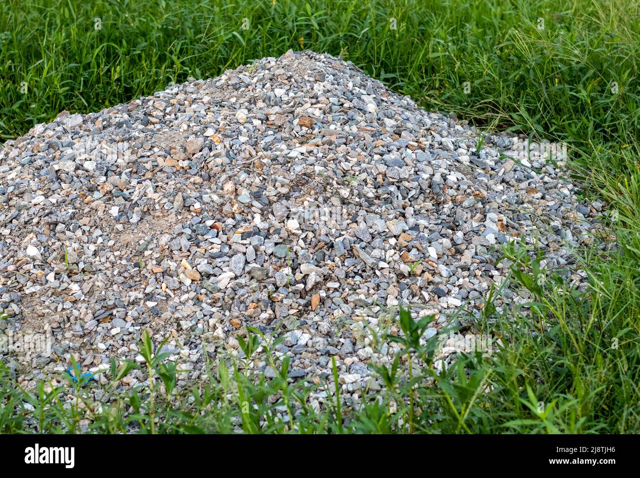 A pile of construction pebble on a meadowland Stock Photo - Alamy