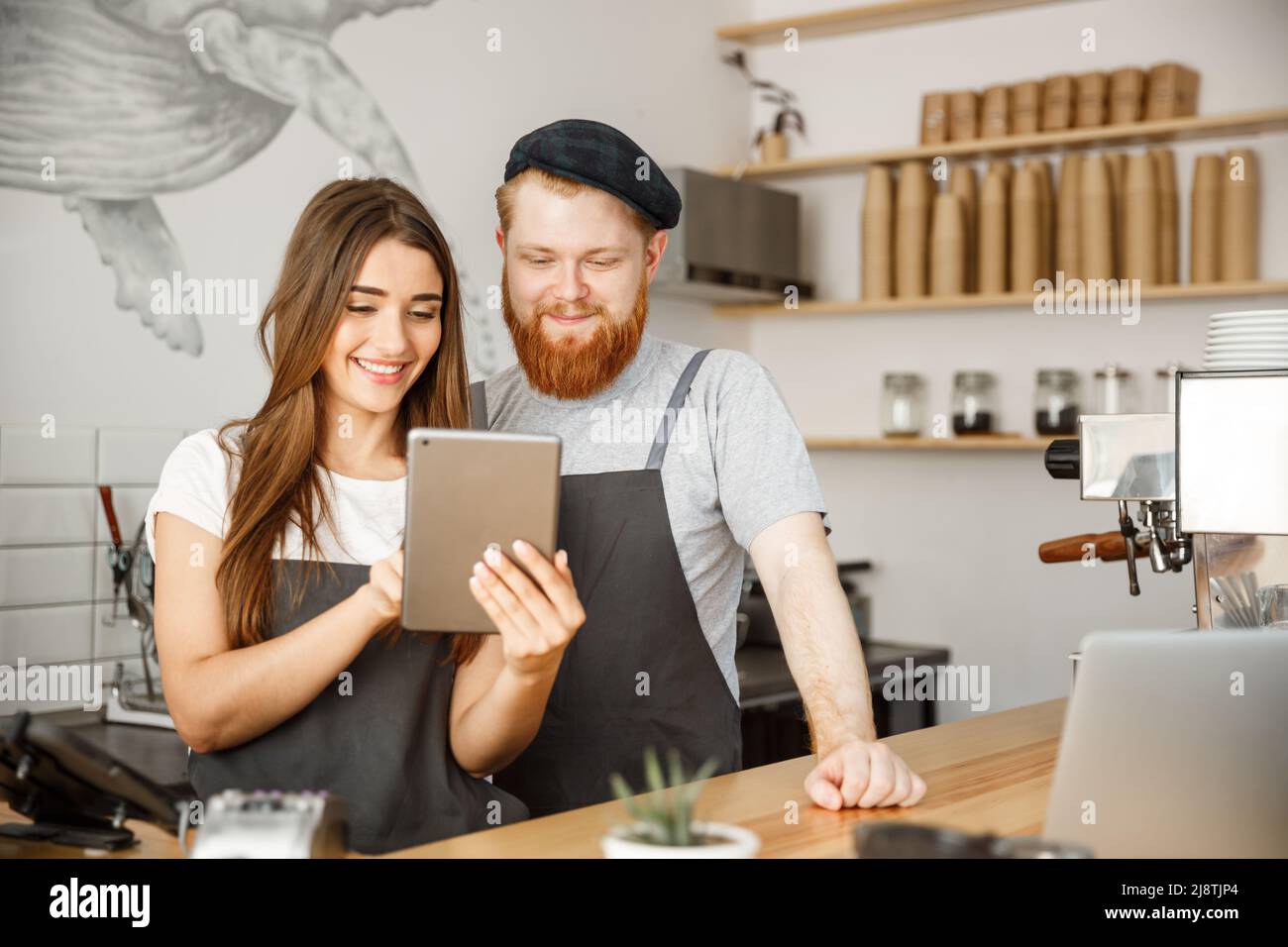 Coffee Business Concept - Satisfied and smile owners couple look on ...