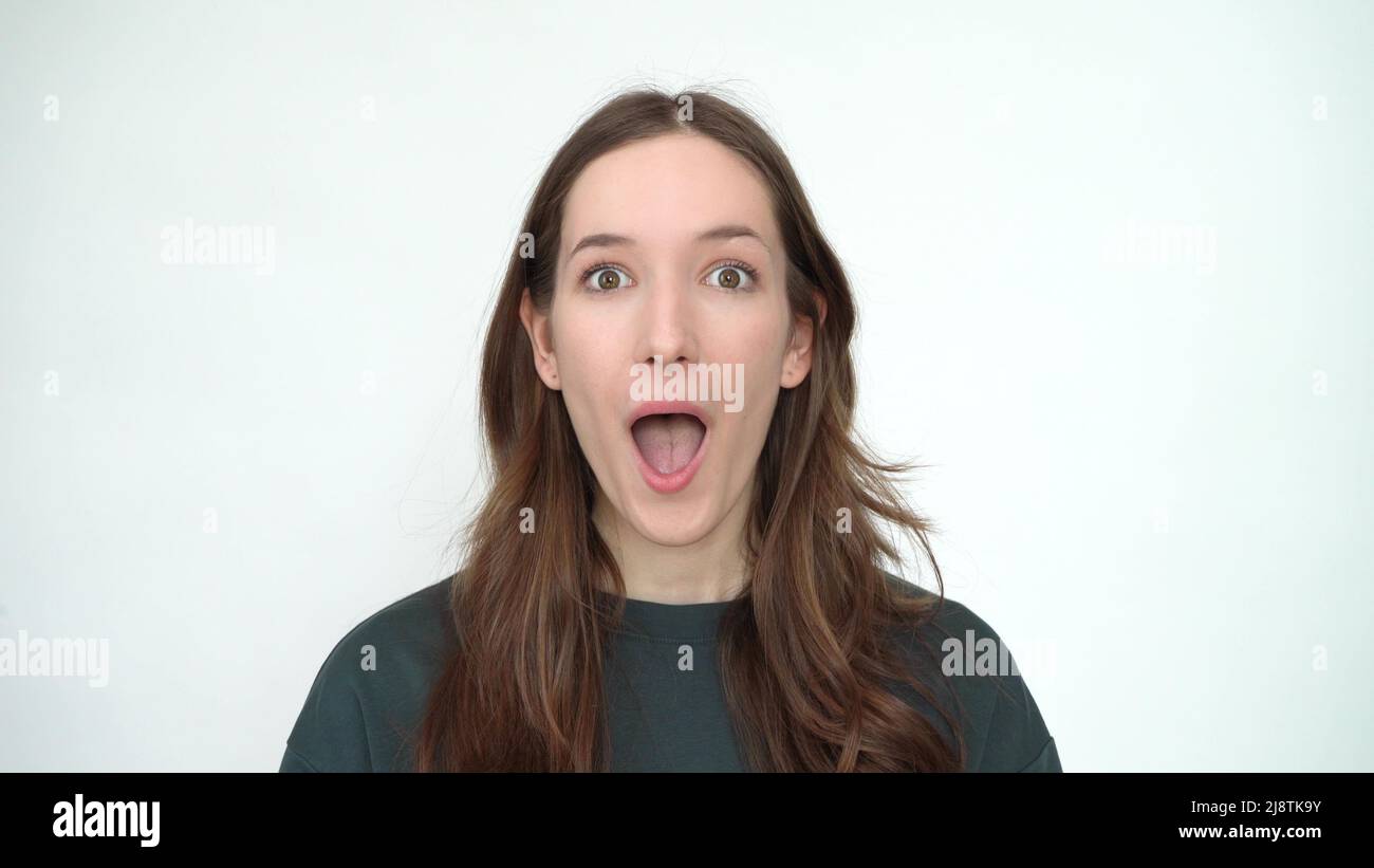 A young woman looks into the camera and sees something intriguing ...