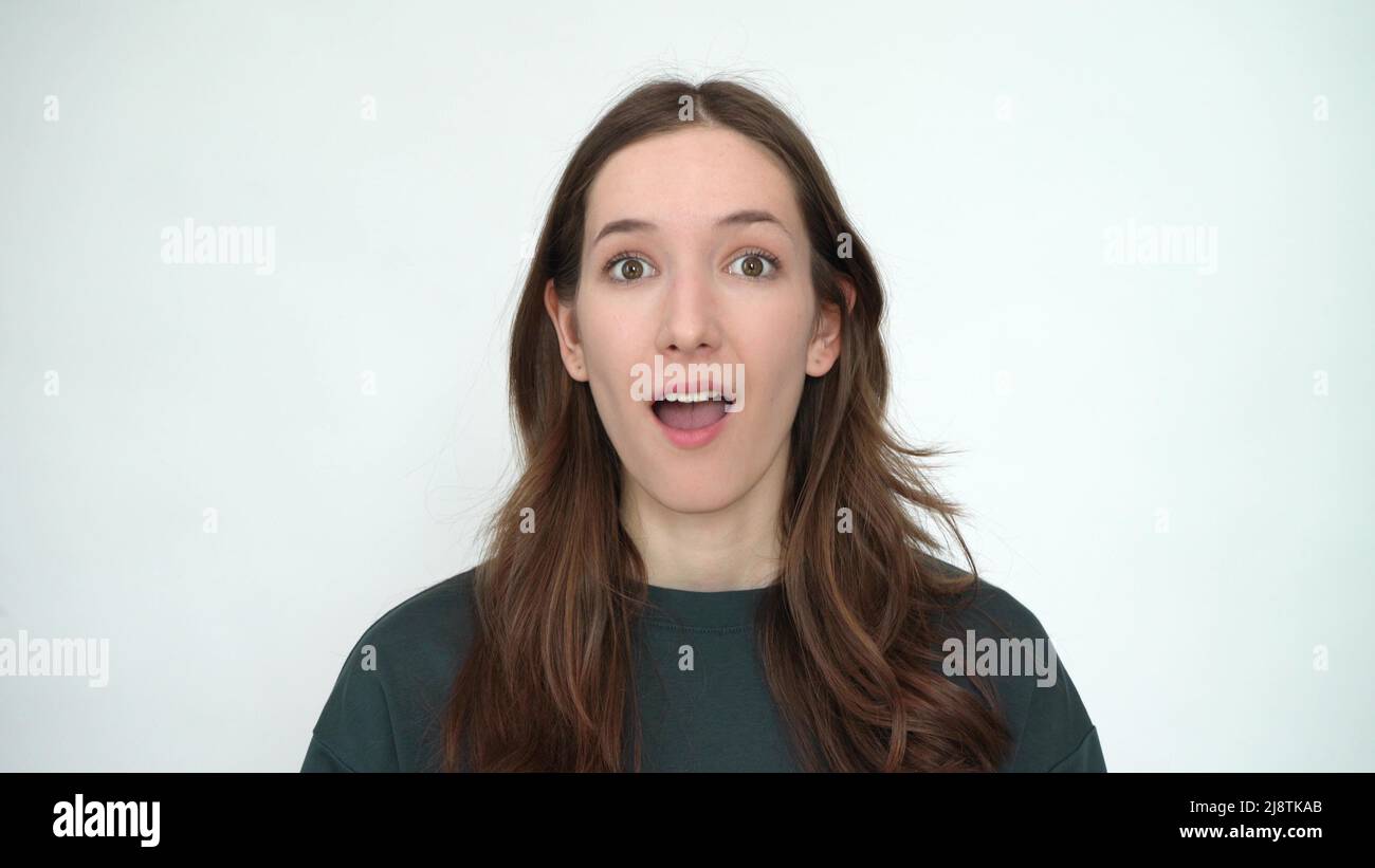 A young woman looks into the camera and sees something intriguing ...