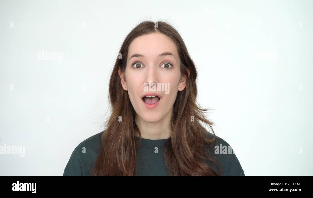 A young woman looks into the camera and sees something intriguing ...