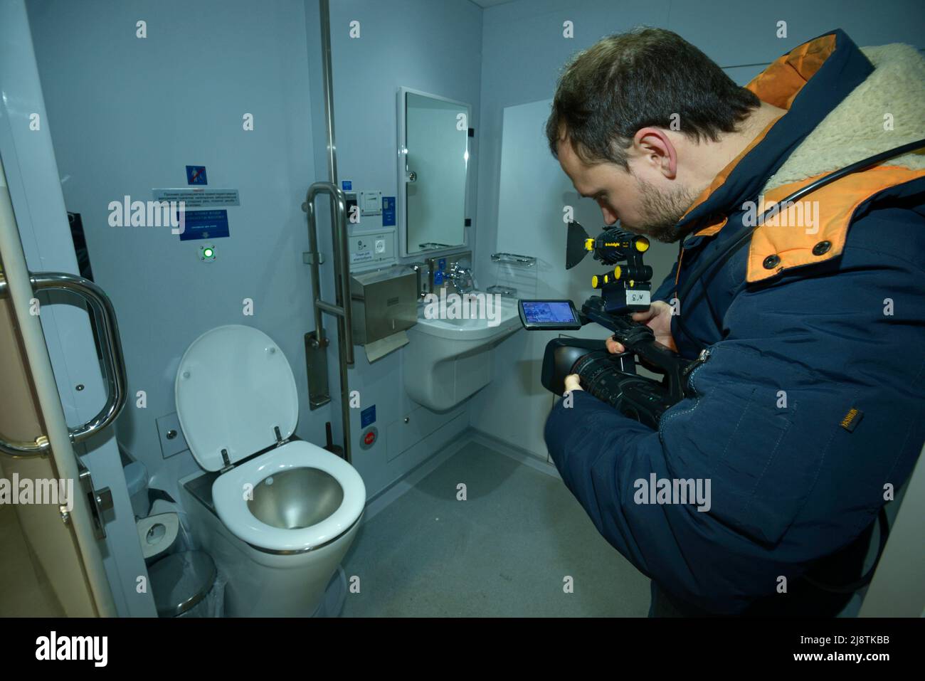 Cameraman making video of a toilet in a passenger train. December 22 ...