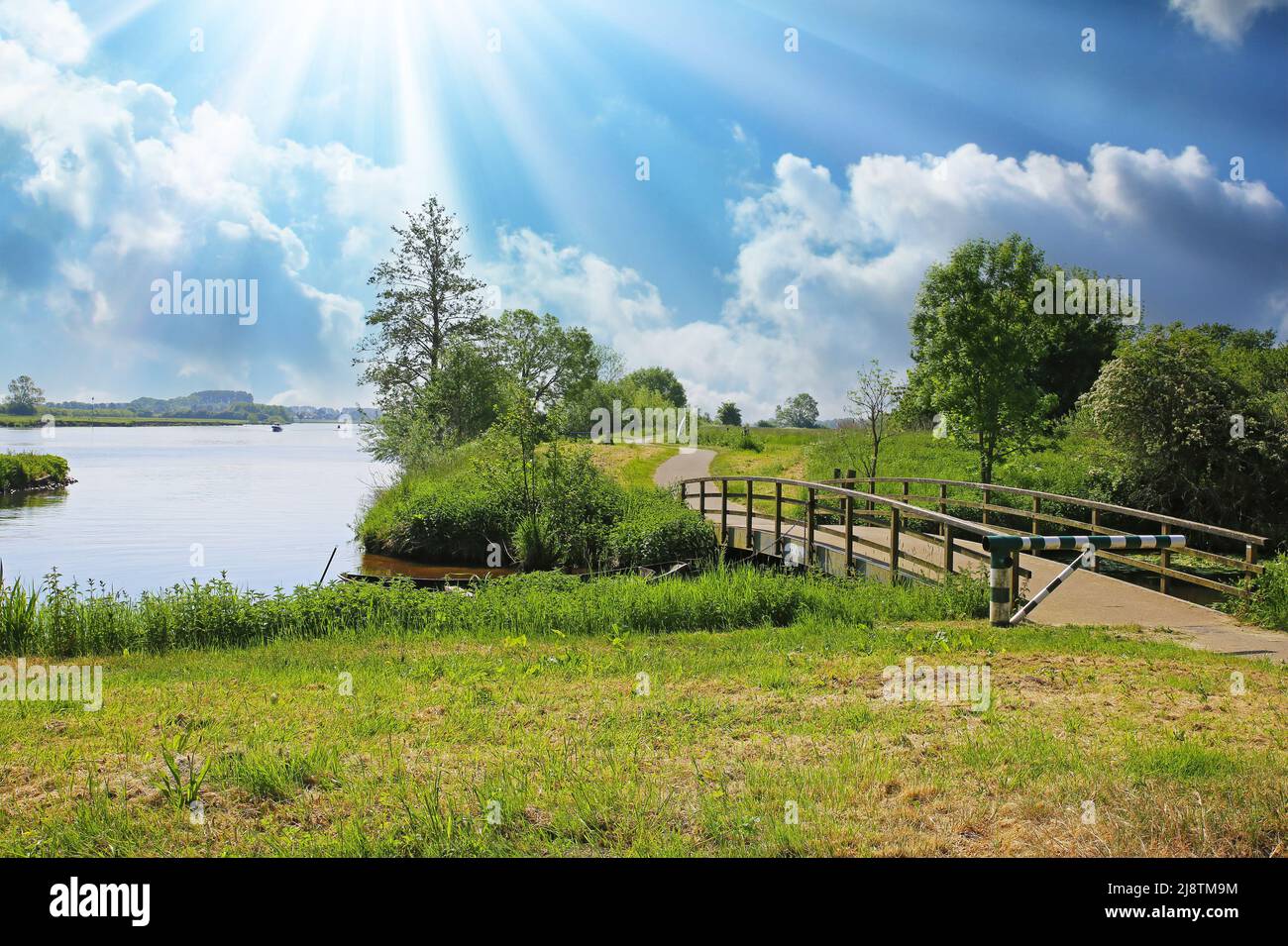Beautiful dutch rural landscape, cycle track along river maas over old ...