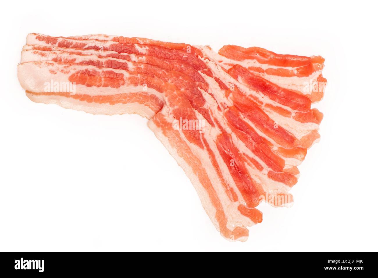 Several pieces of bacon cut into strips on a white background Stock ...