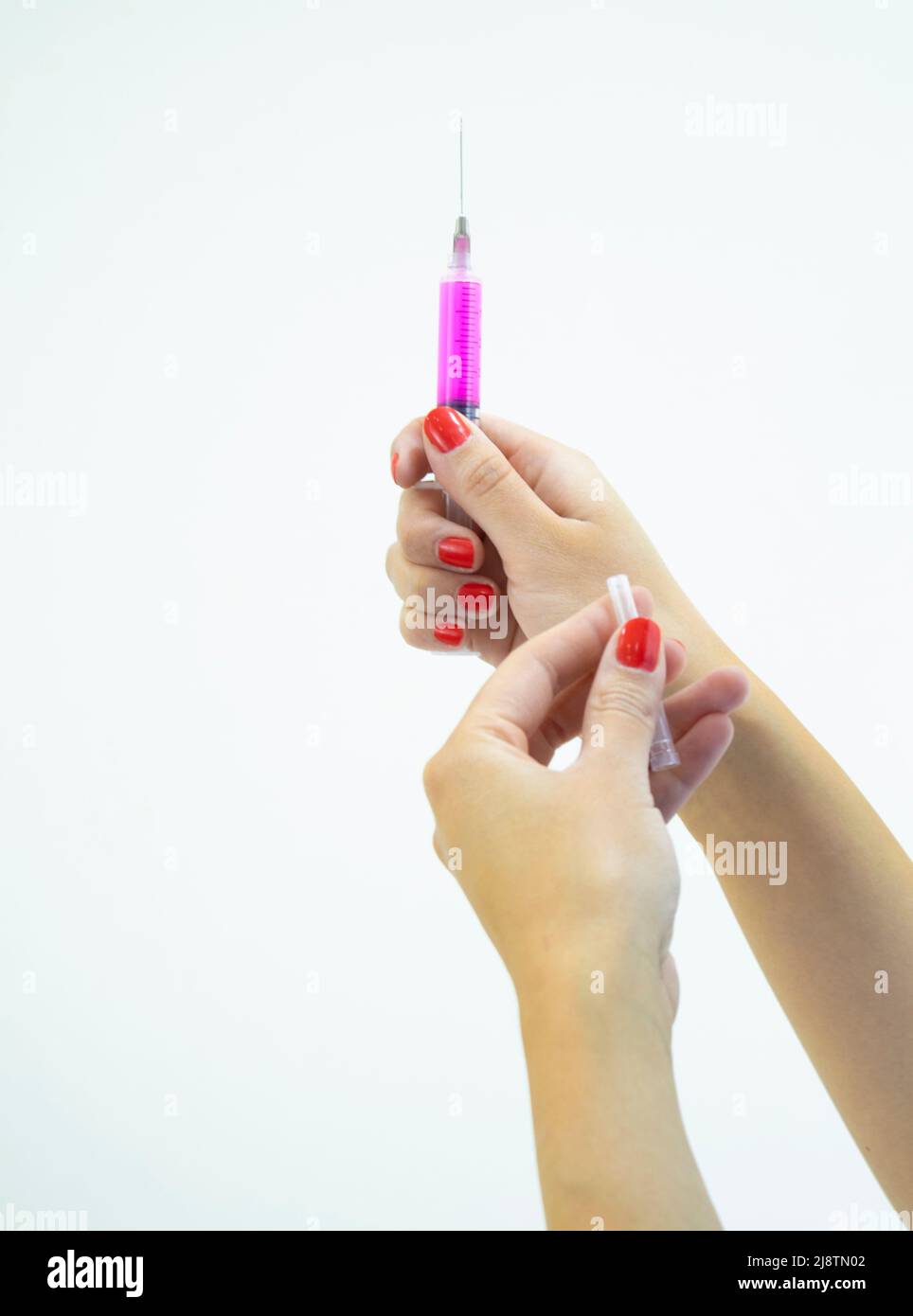 Professional laboratory technician preparing injection on white ...