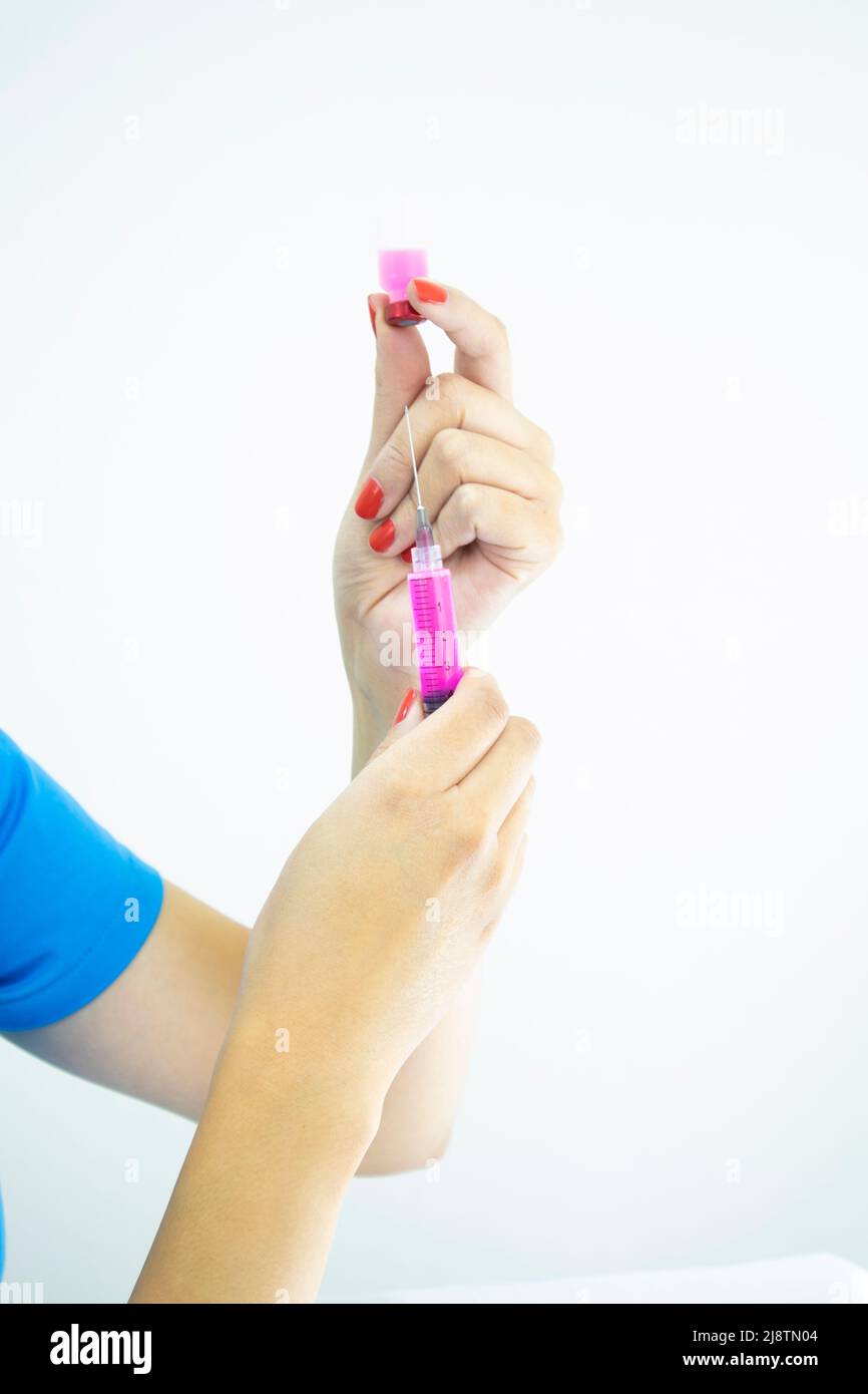 Professional laboratory technician preparing injection on white ...