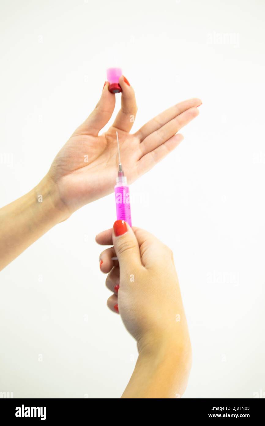 Professional laboratory technician preparing injection on white ...