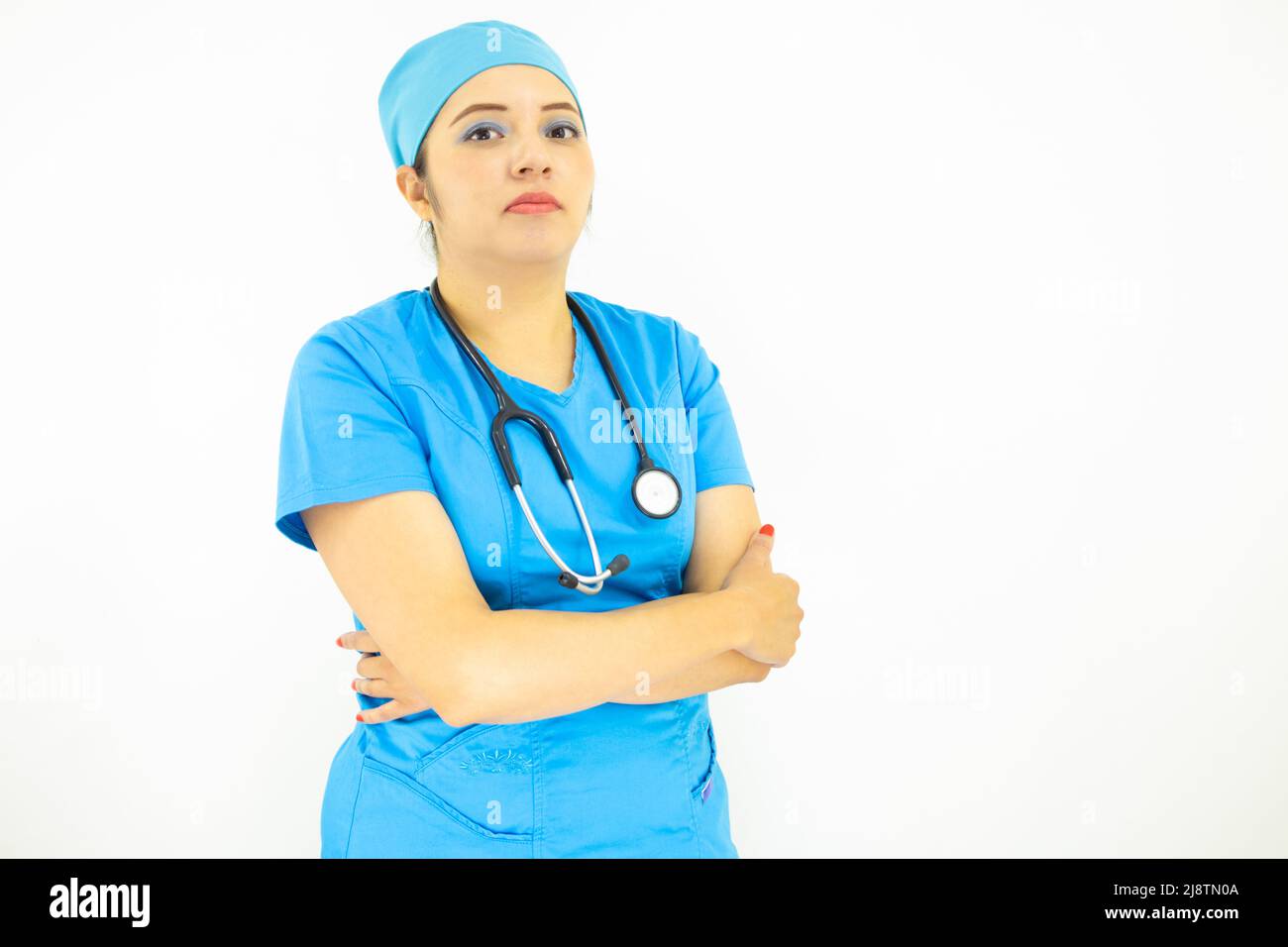 Beautiful female doctor wearing uniform and blue surgical cap ...