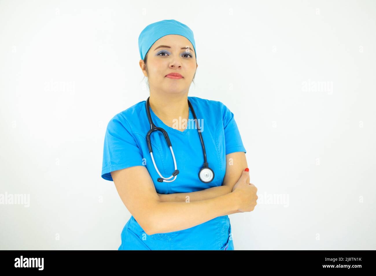 Beautiful female doctor wearing uniform and blue surgical cap ...