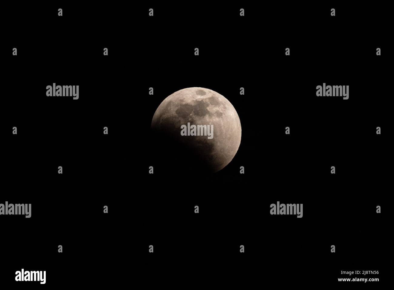 Full moon partially obscured; beginning of full lunar eclipse. Black ...
