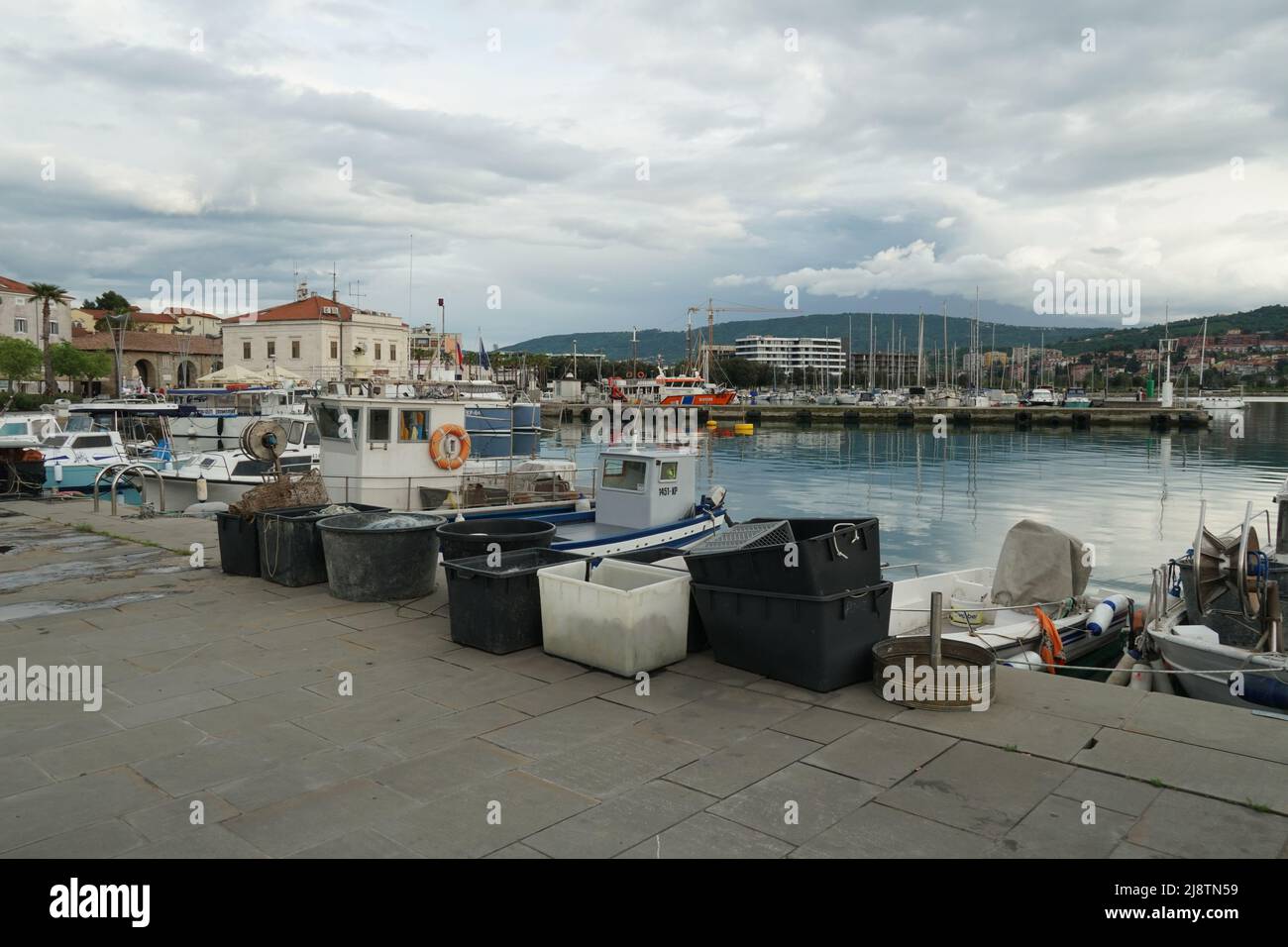 Oval plastic buckets and boxes filled with fishing nets ready to load ...