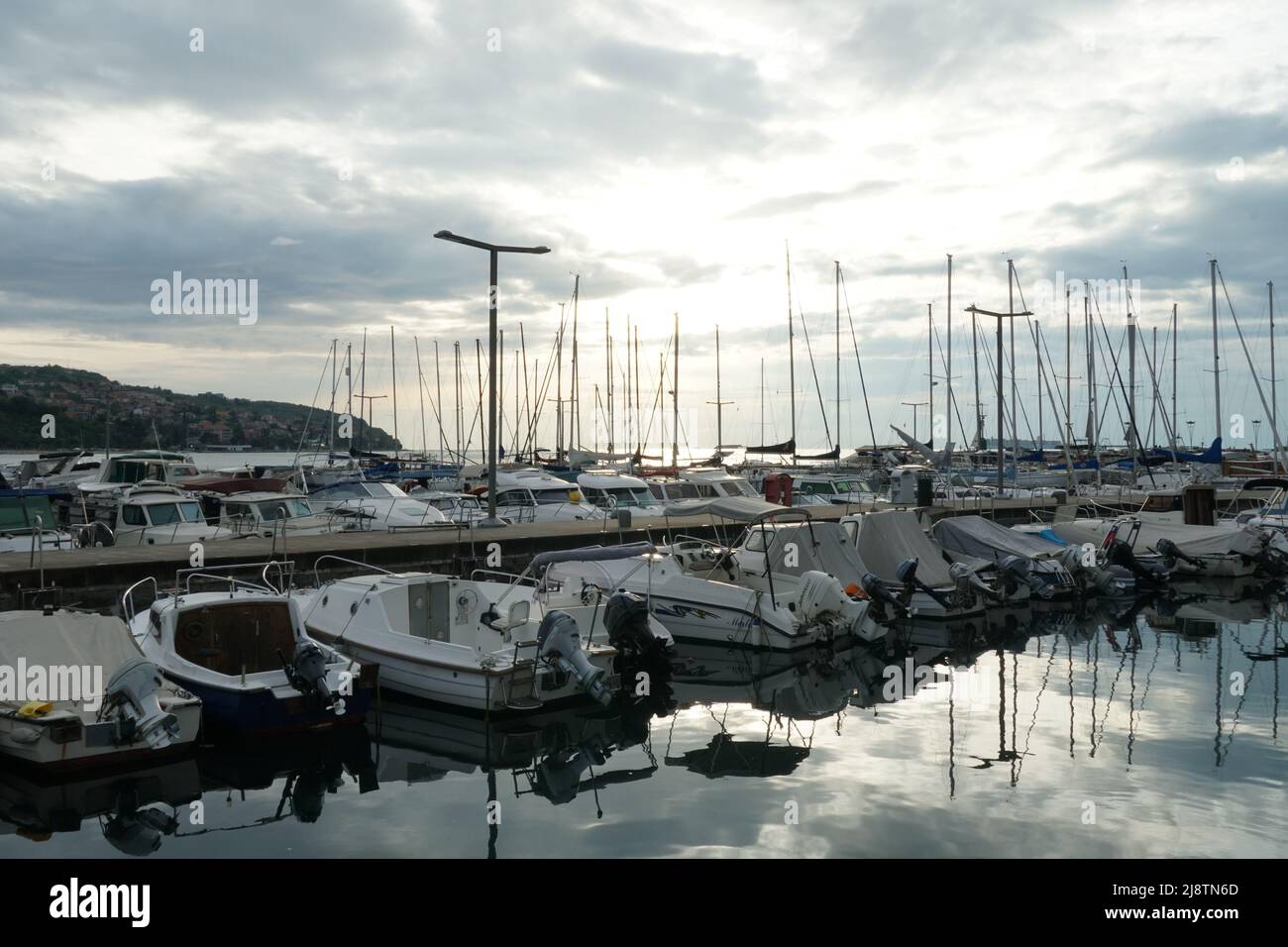 Many white yachts and pleasure private boats moored in marina in town ...