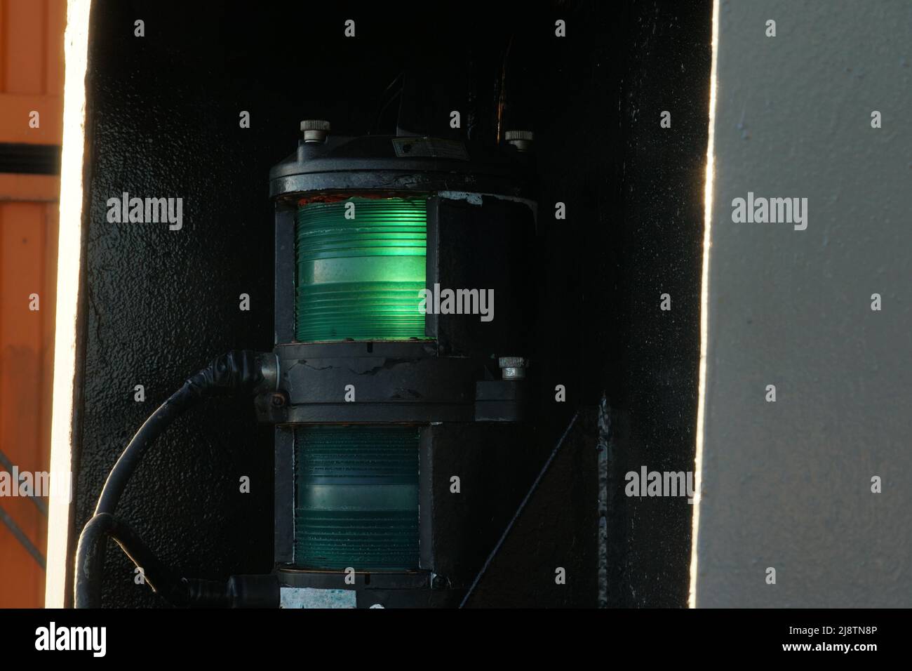 Close view on green starboard side navigational lights of the container ...