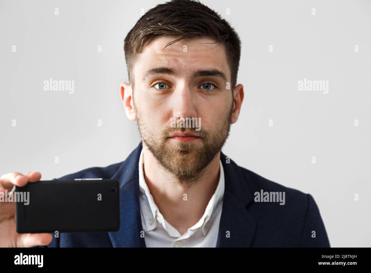 Business Concept - Handsome Business man take a selfie of himself with ... Business Concept - Handsome Business man take a selfie of himself with ...