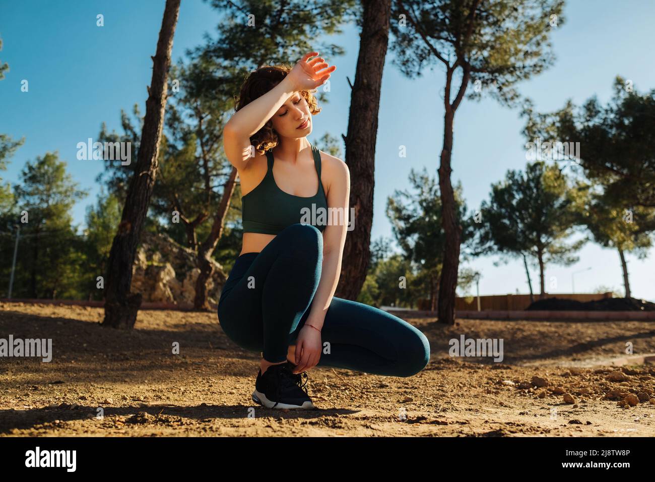 Young beautiful and attractive sport redhead woman in runner sportswear ...