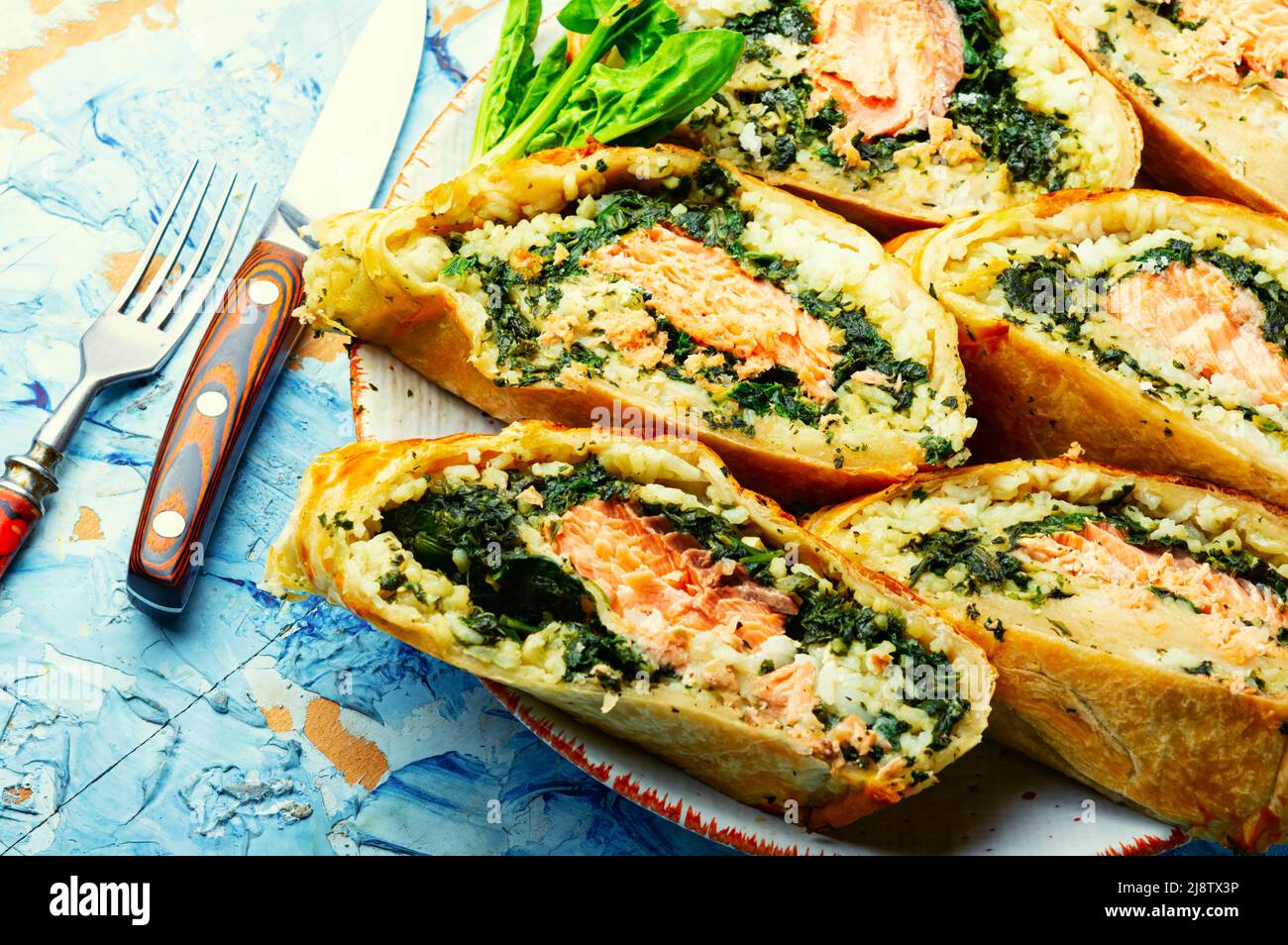 Tasty roll with salmon, rice and spinach. Fish pie. Fish wellington ...