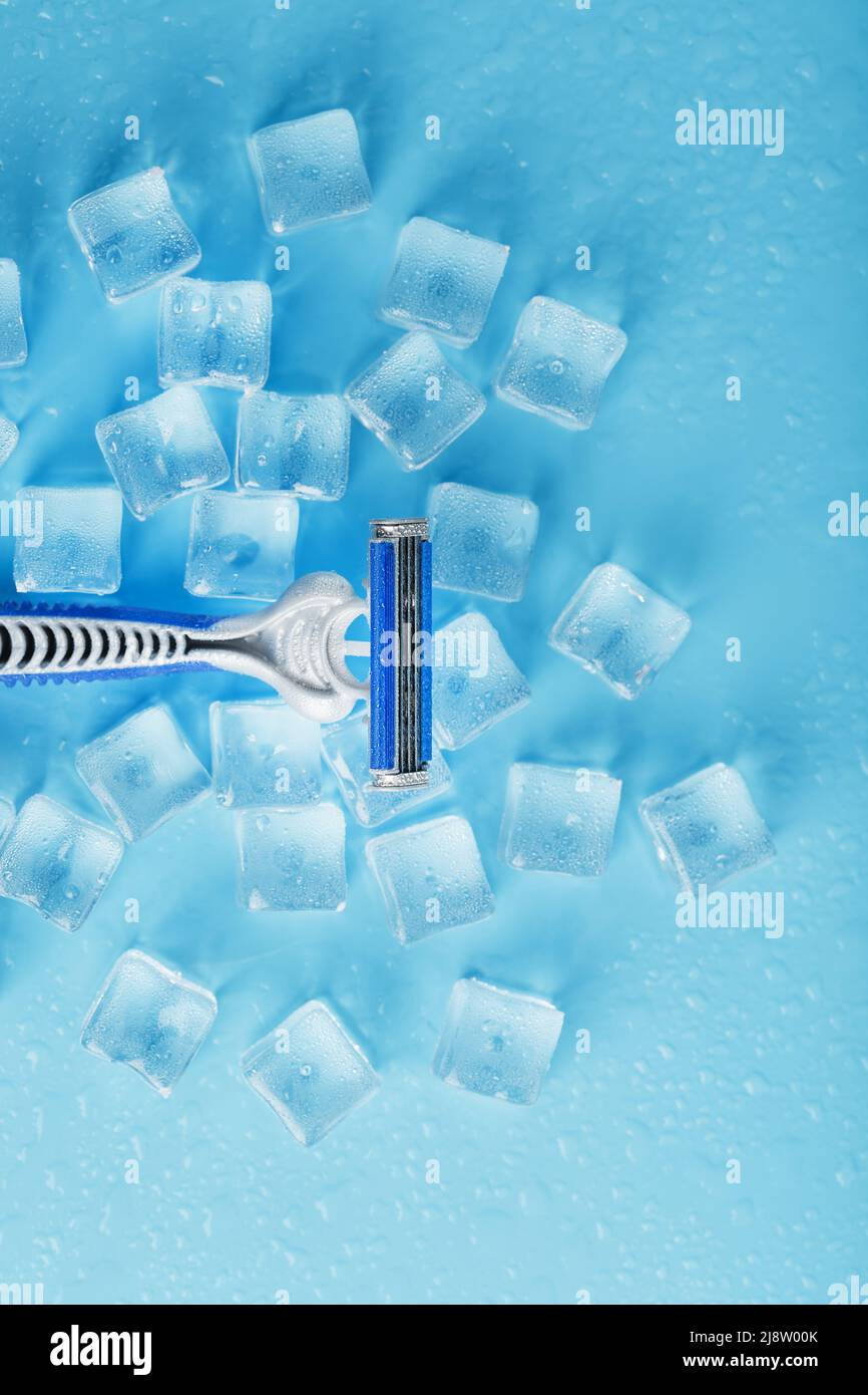 Shaving machine on a blue background with ice cubes. The concept of ...