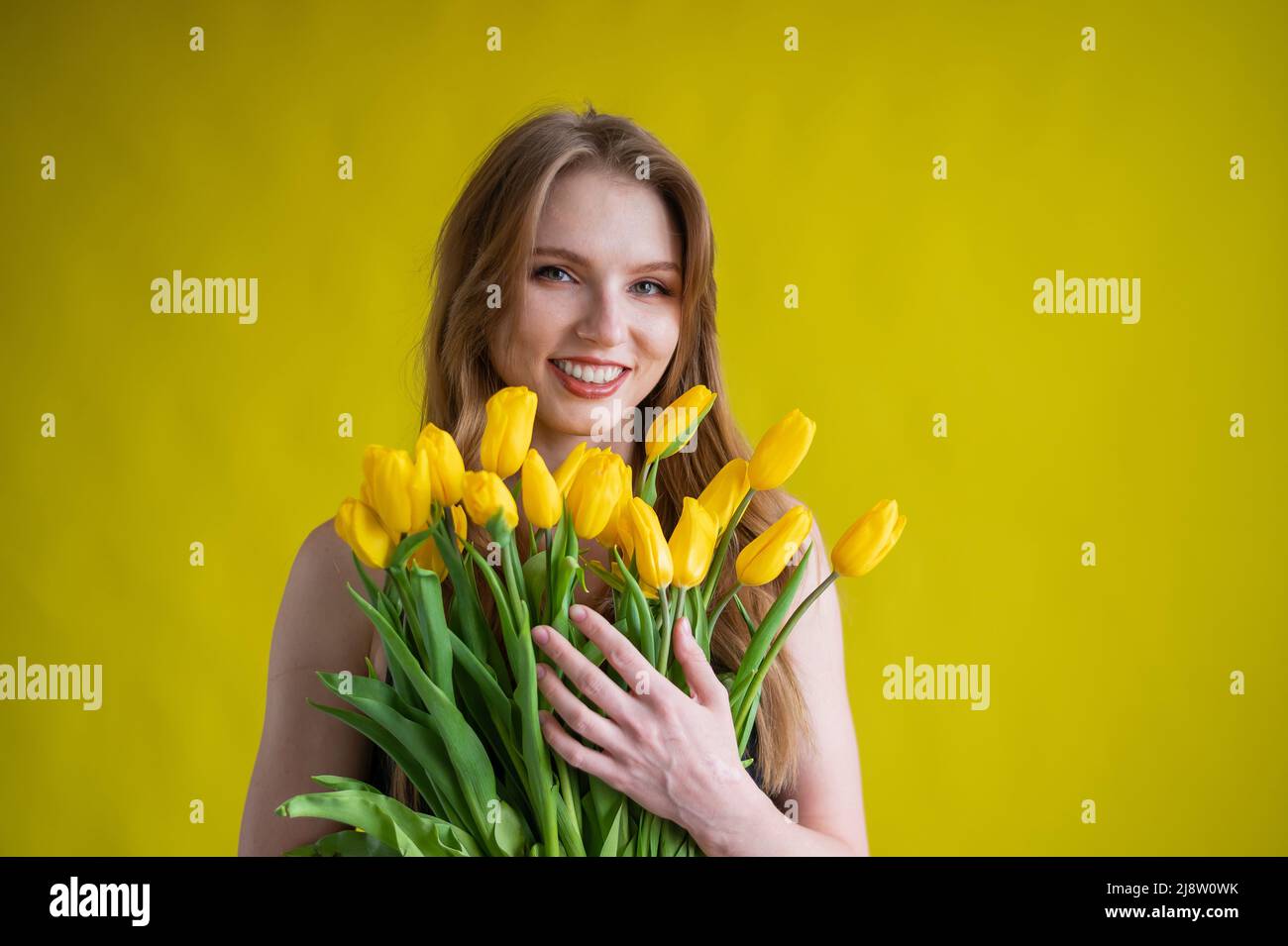 Woman holding armful flowers hi-res stock photography and images - Alamy