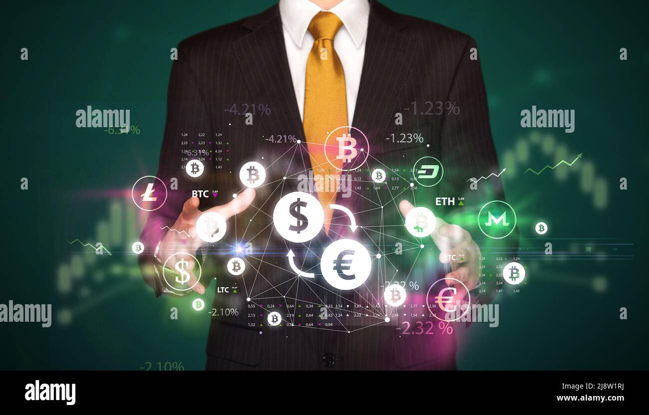 Businessman holding currency symbols concept Stock Photo - Alamy