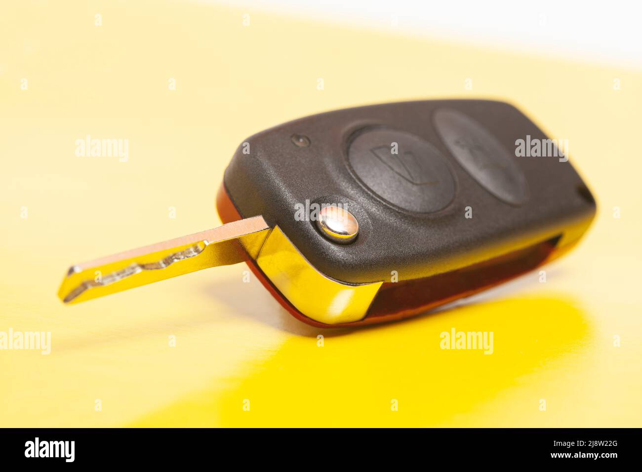 New car key on yellow background Stock Photo - Alamy