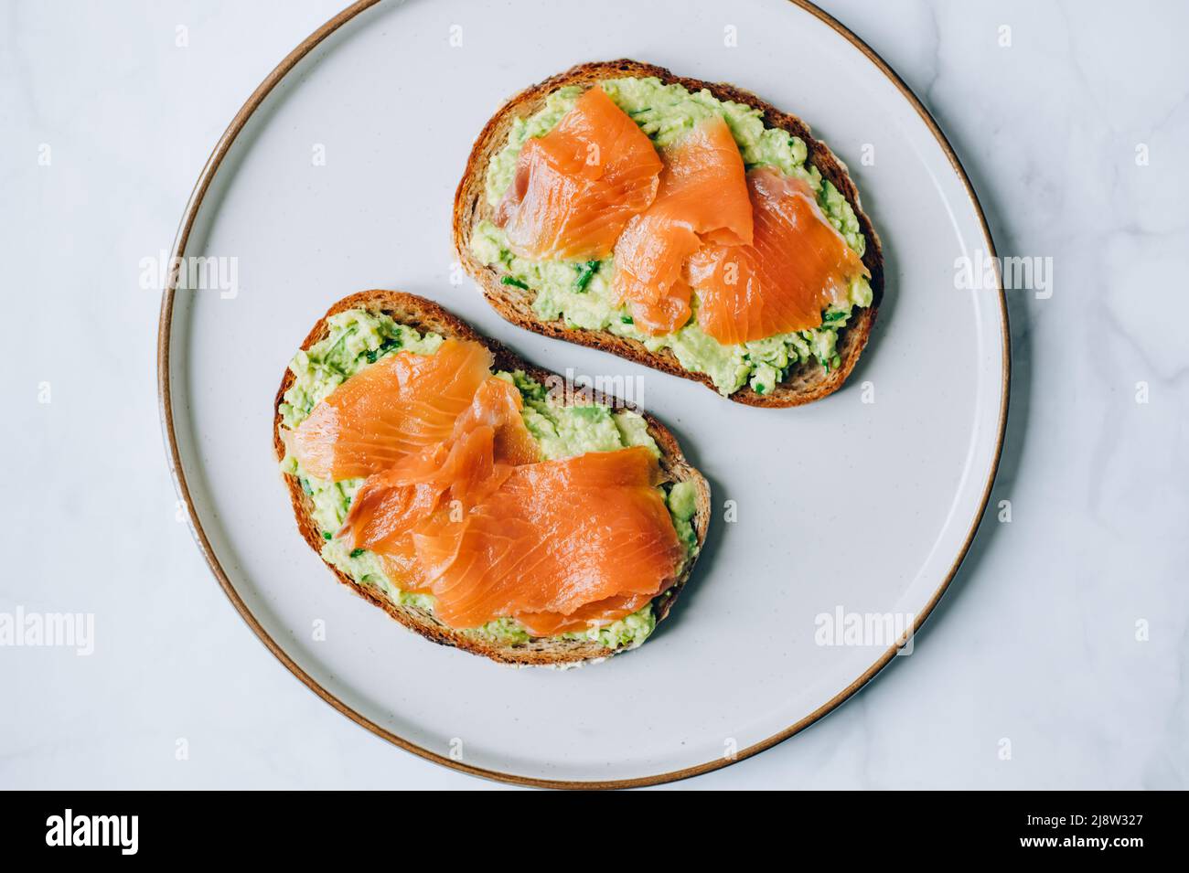 Toast with avocado and salmon Stock Photo - Alamy