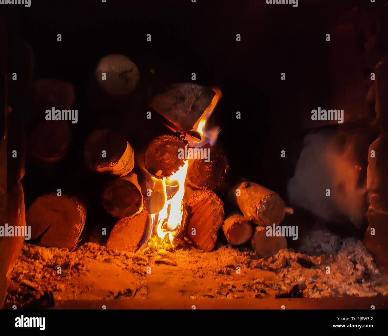Burning firewood in fireplace in country cottage Stock Photo - Alamy