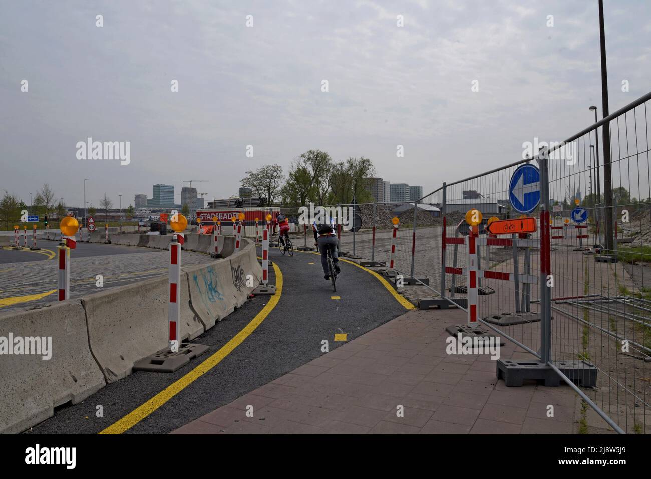People cycling on a temporary cycle path through roadworks in Antwerp ...