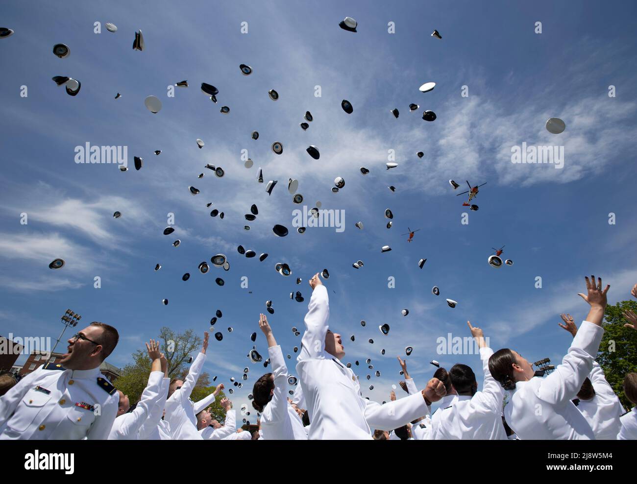 United States Coast Guard Ensigns toss their caps in the air at the ...