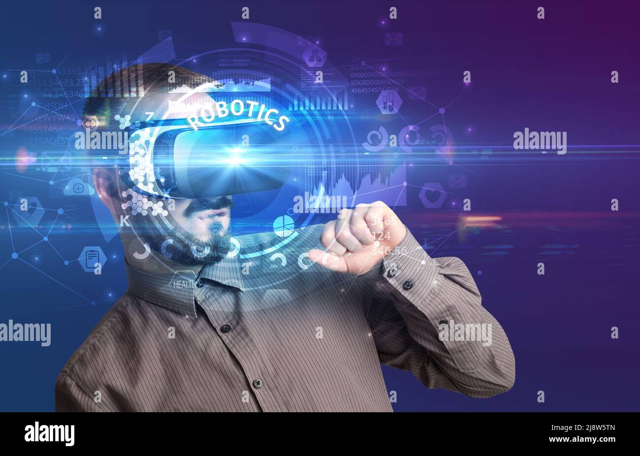 Businessman looking through VR glasses Stock Photo - Alamy