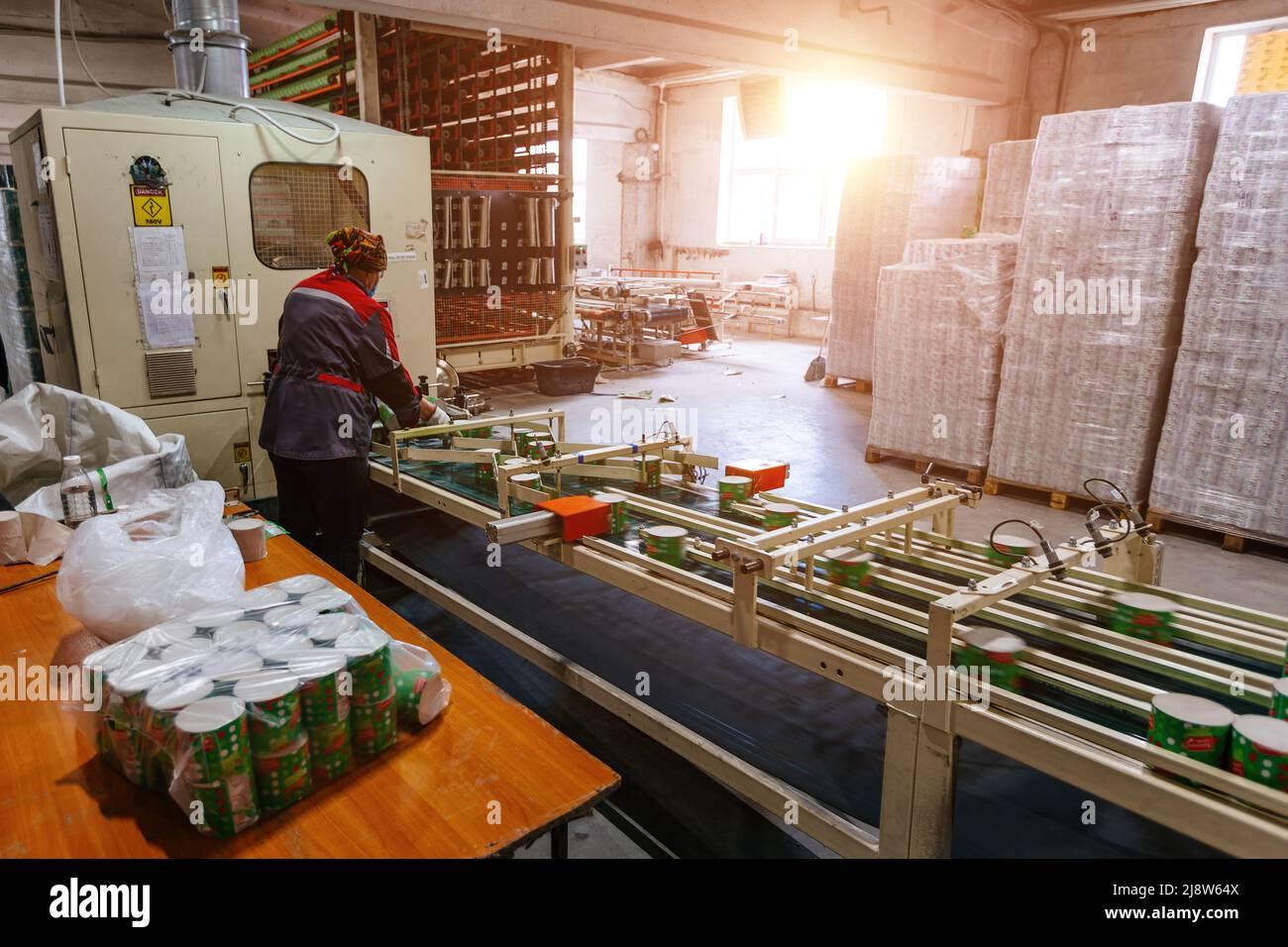 Toilet paper production line. Worker with conveyor Stock Photo - Alamy