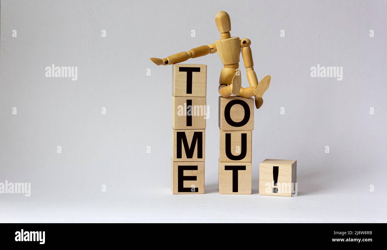 Time Out text written on Wooden Blocks with wooden puppet on white ...