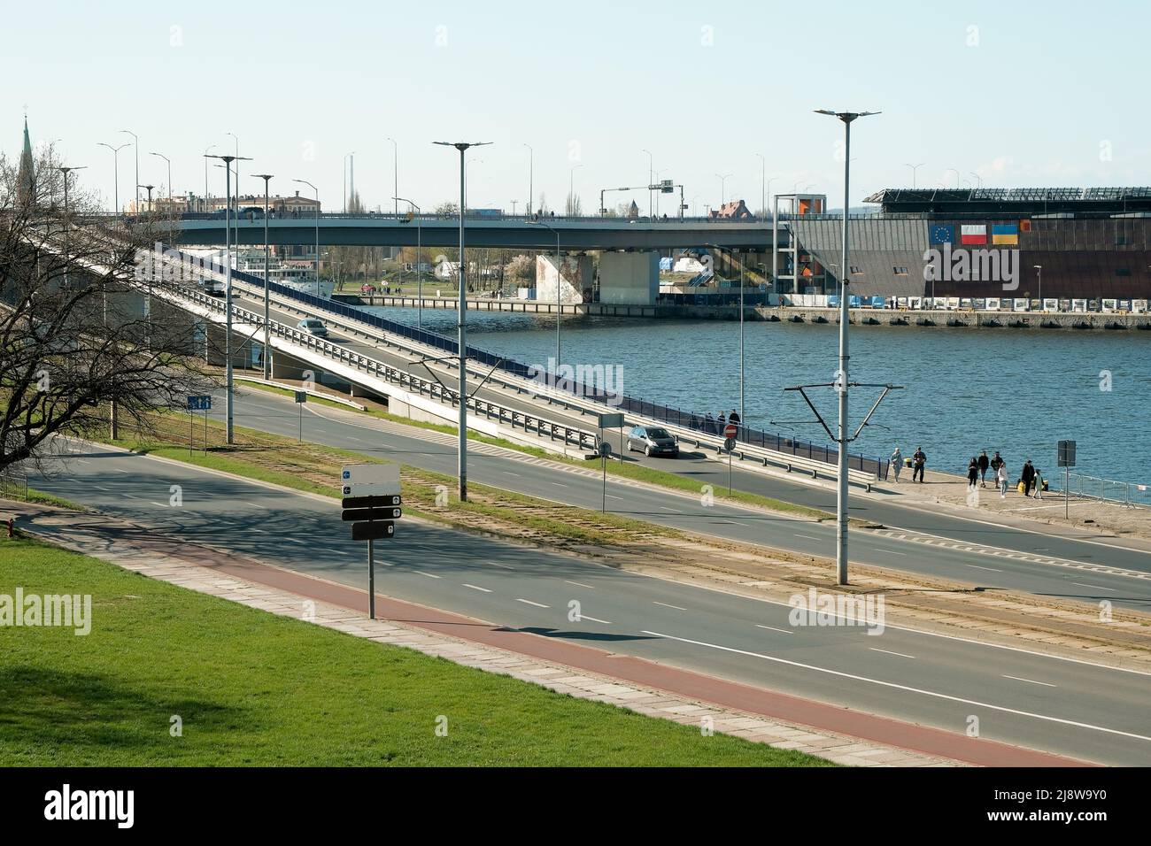 Dusk colored clouds in the background, highway overpass curved approach ...