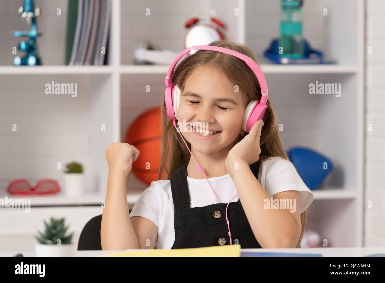 happy kid listen to music in headphones at school classroom Stock Photo ...