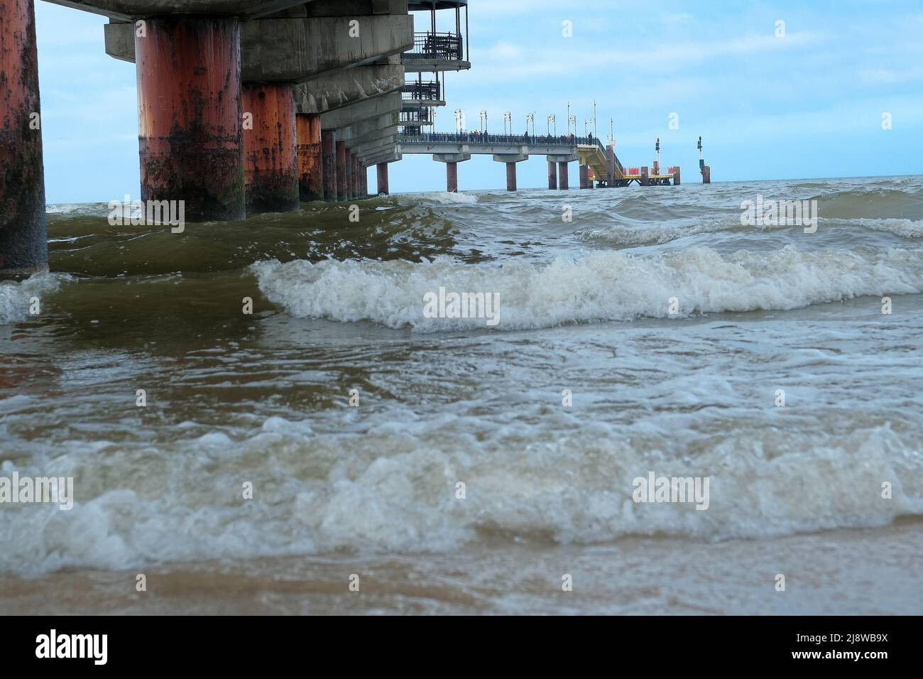 bridge extending into the distance of the sea. high sea waves . sea ...
